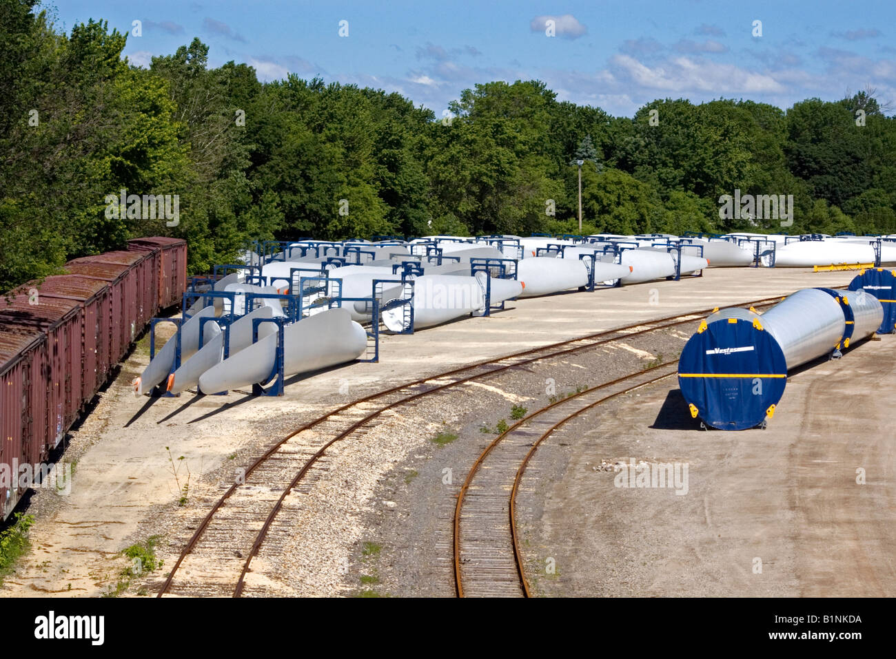 Windmill blades and tower sections at railroad transfer point awaiting ...