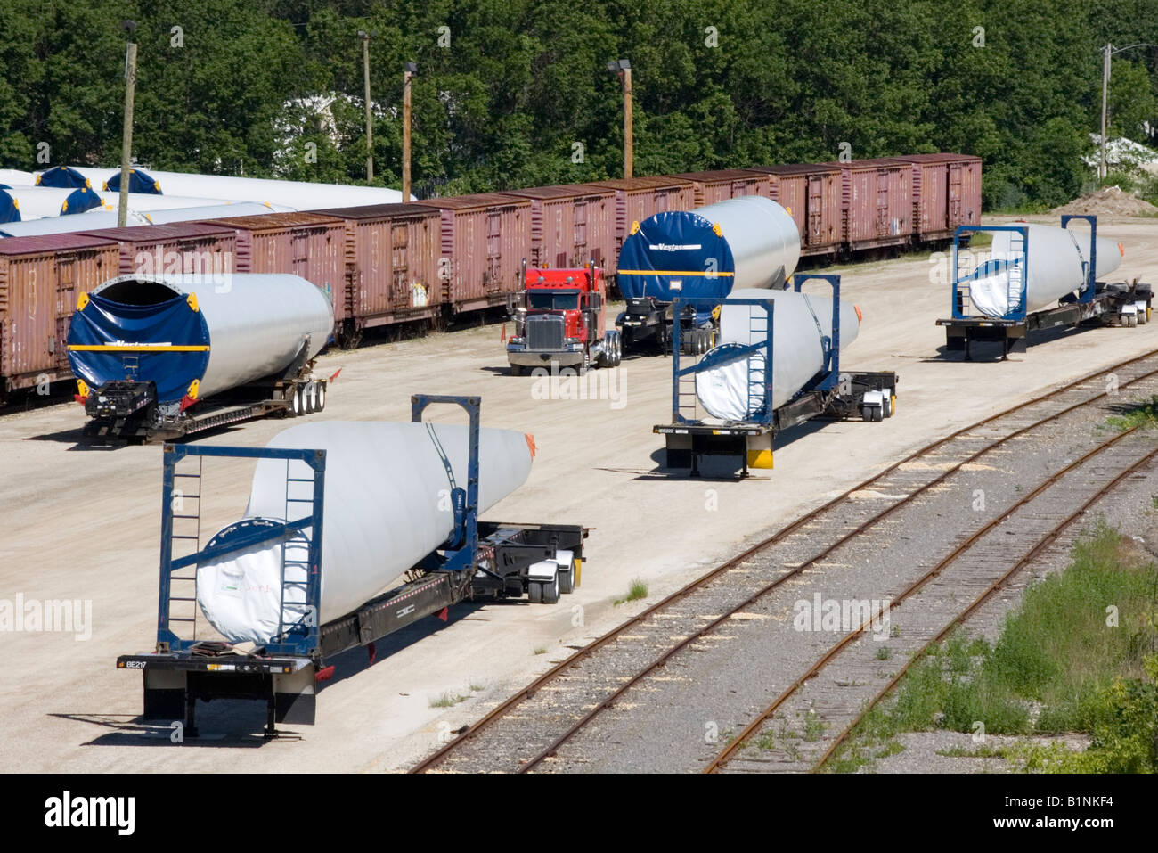 Wind Turbine Windmill Blades And Tower Sections Loaded On Trailers For
