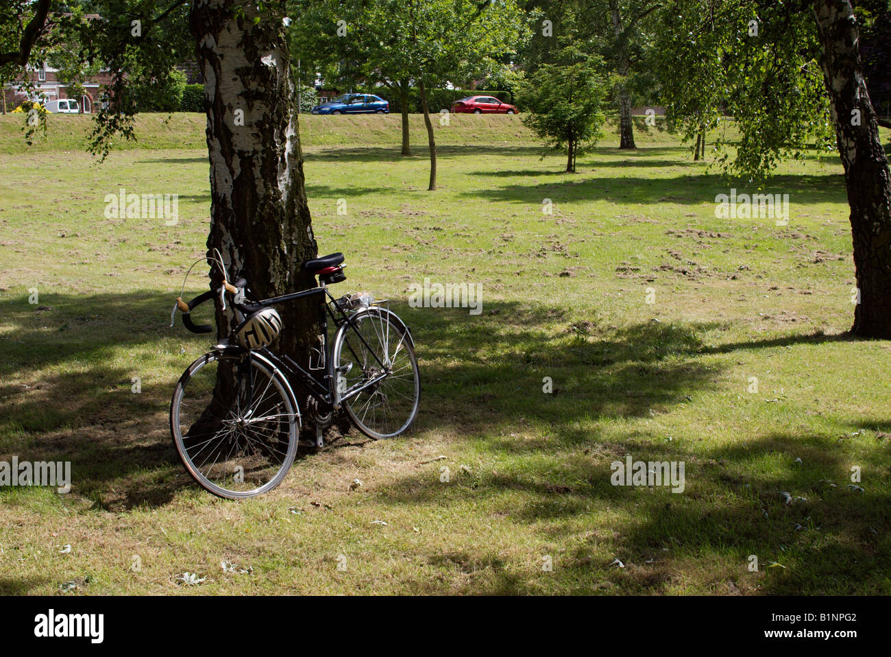 Bicycle touring type leaning against a tree in Woking Surrey England ...