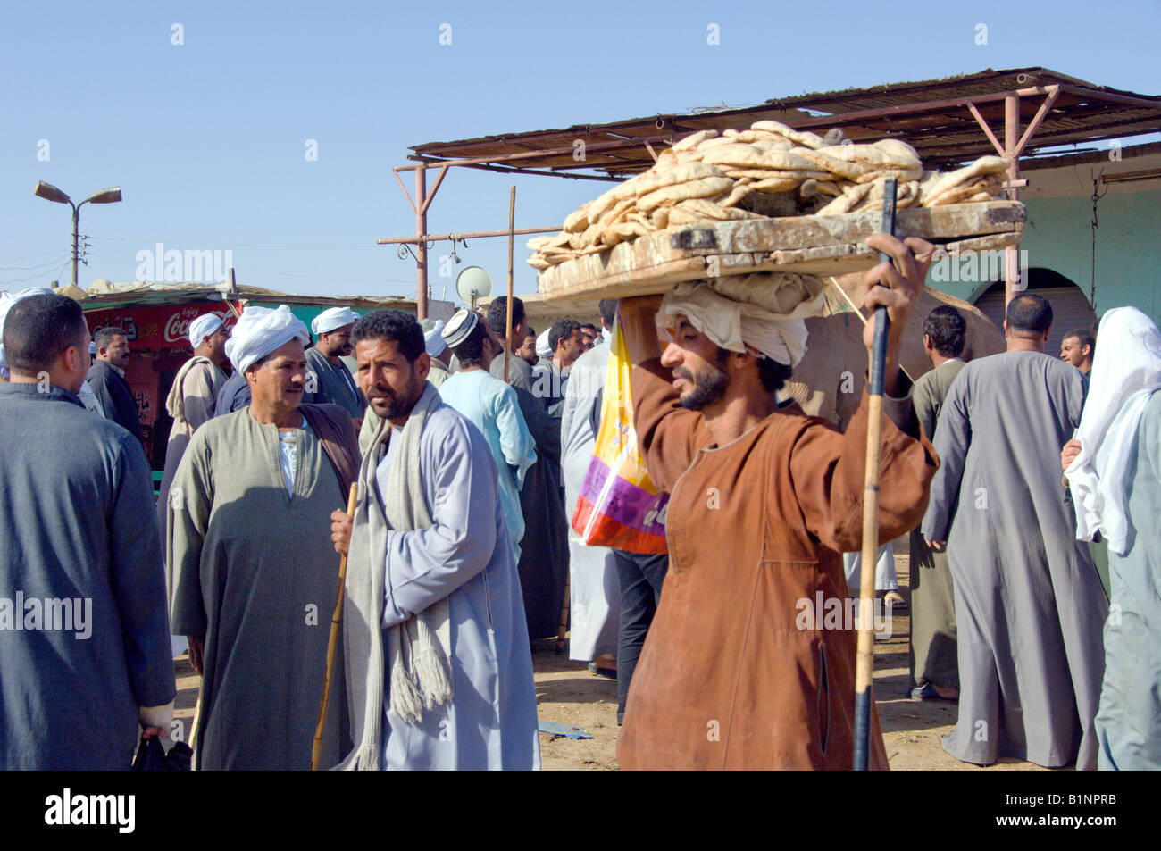 A man carrying bread on his head at the Birqash Camel Market near Cairo ...