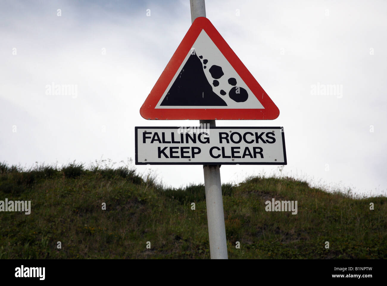 Falling rocks warning sign on coast, England Stock Photo - Alamy