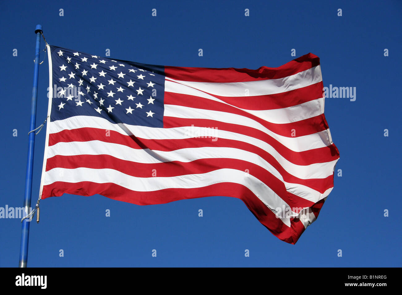 An American flag flaping boldly in the wind Stock Photo - Alamy