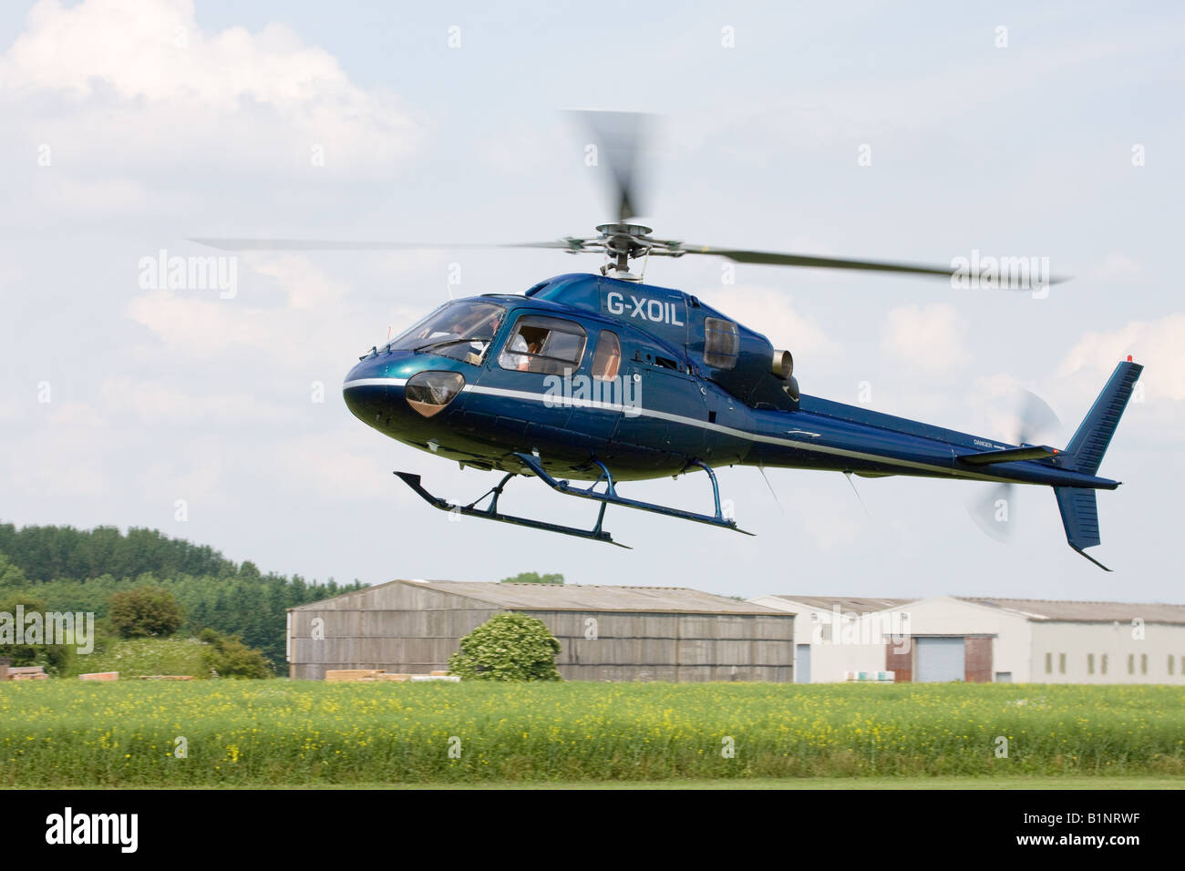 Eurocopter AS355N Ecureuil 11 G-XOIL in flight taking-off from ...
