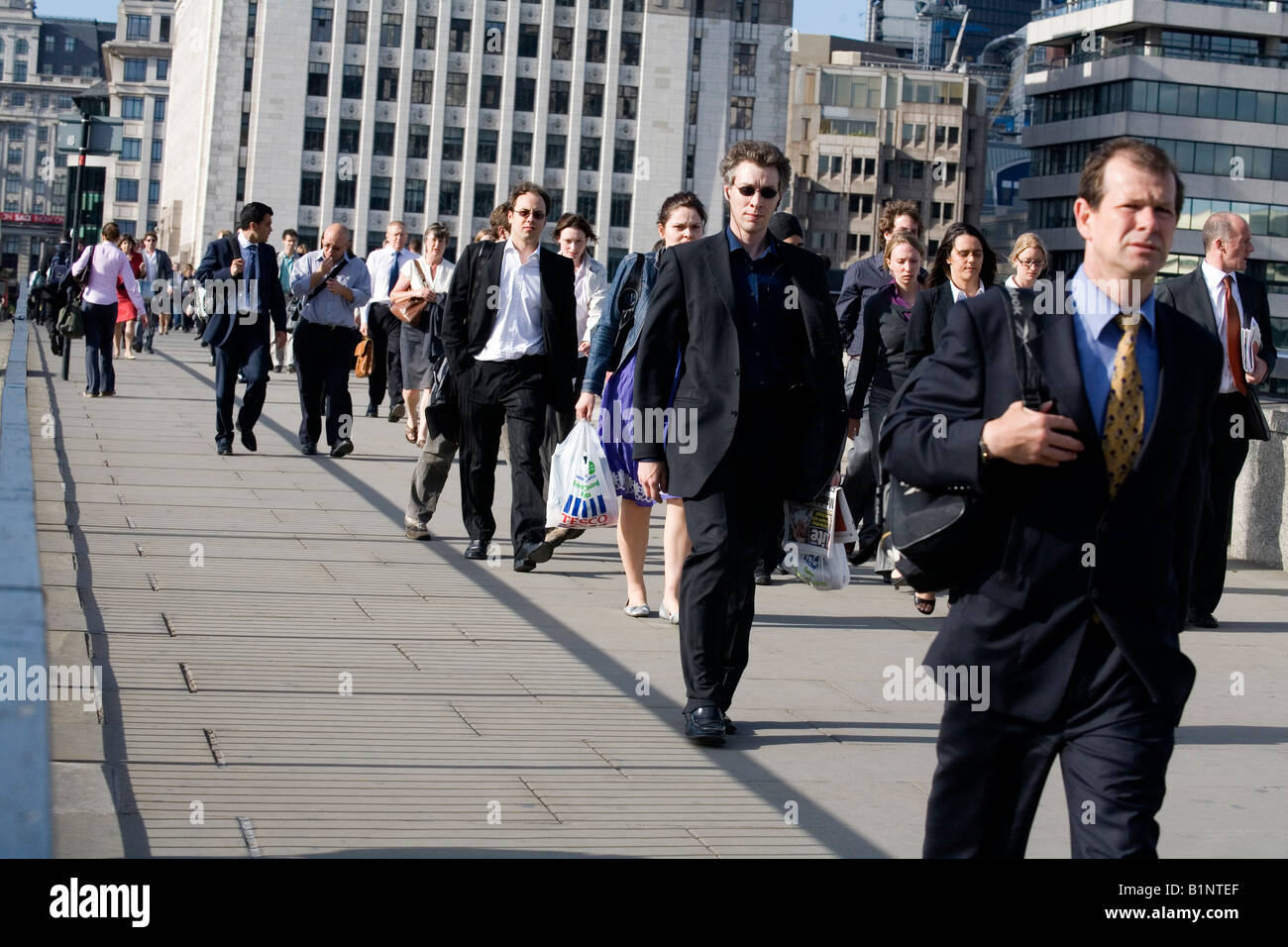 People crossing London bridge at rush hours London England Britain UK ...