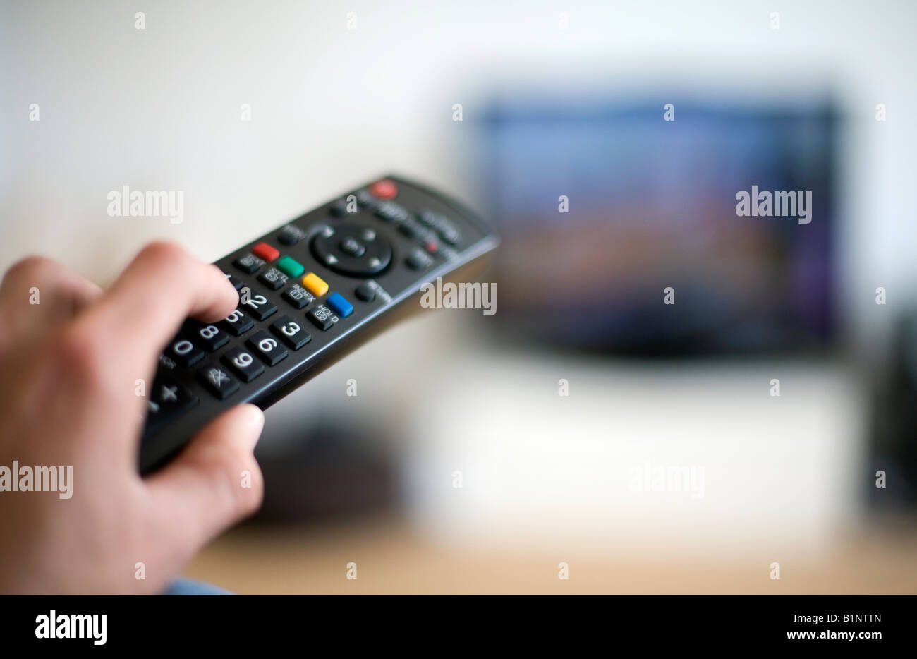 A hand held Remote Control being used on a television Stock Photo - Alamy
