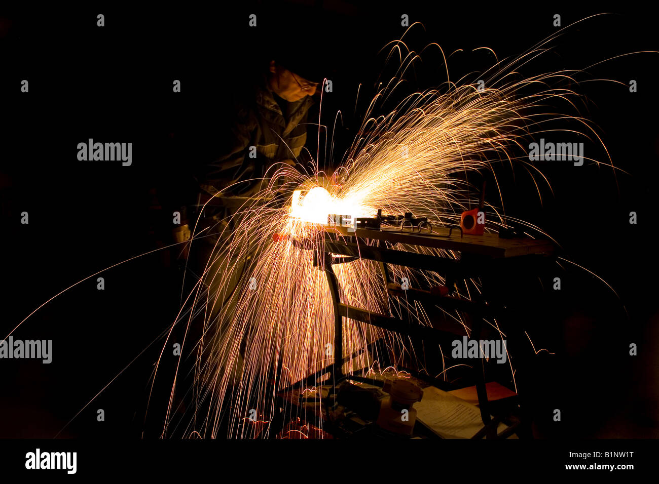 Worker creating sparks in while cutting steel Stock Photo - Alamy