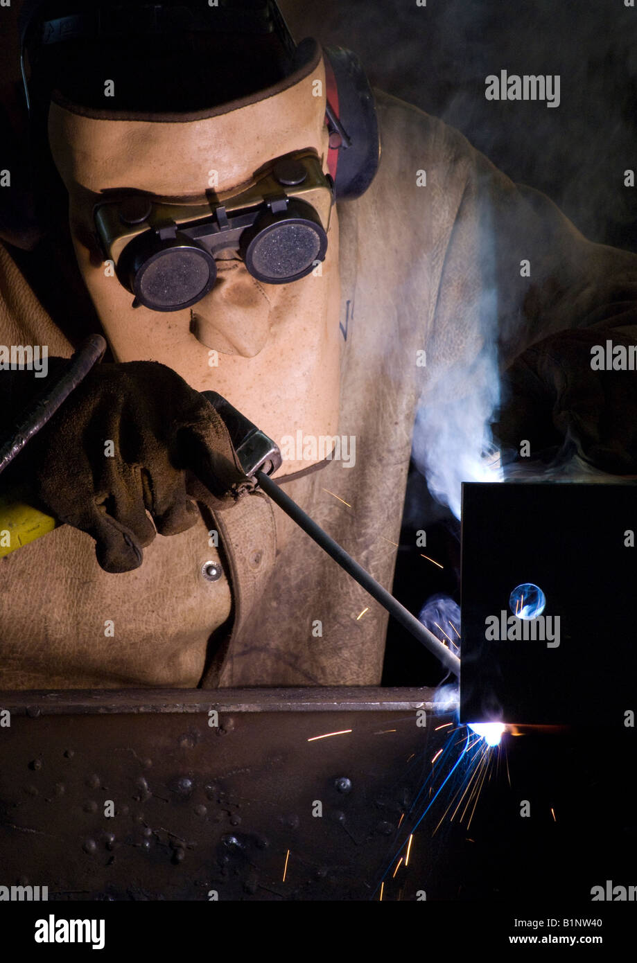A welder in mask and protective clothing Stock Photo - Alamy