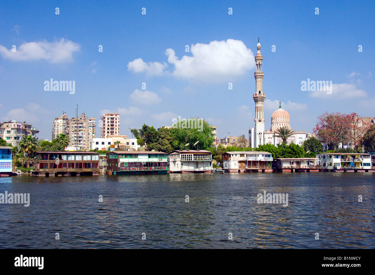 Houseboats along the Nile river with a mosque in Cairo Egypt Stock ...