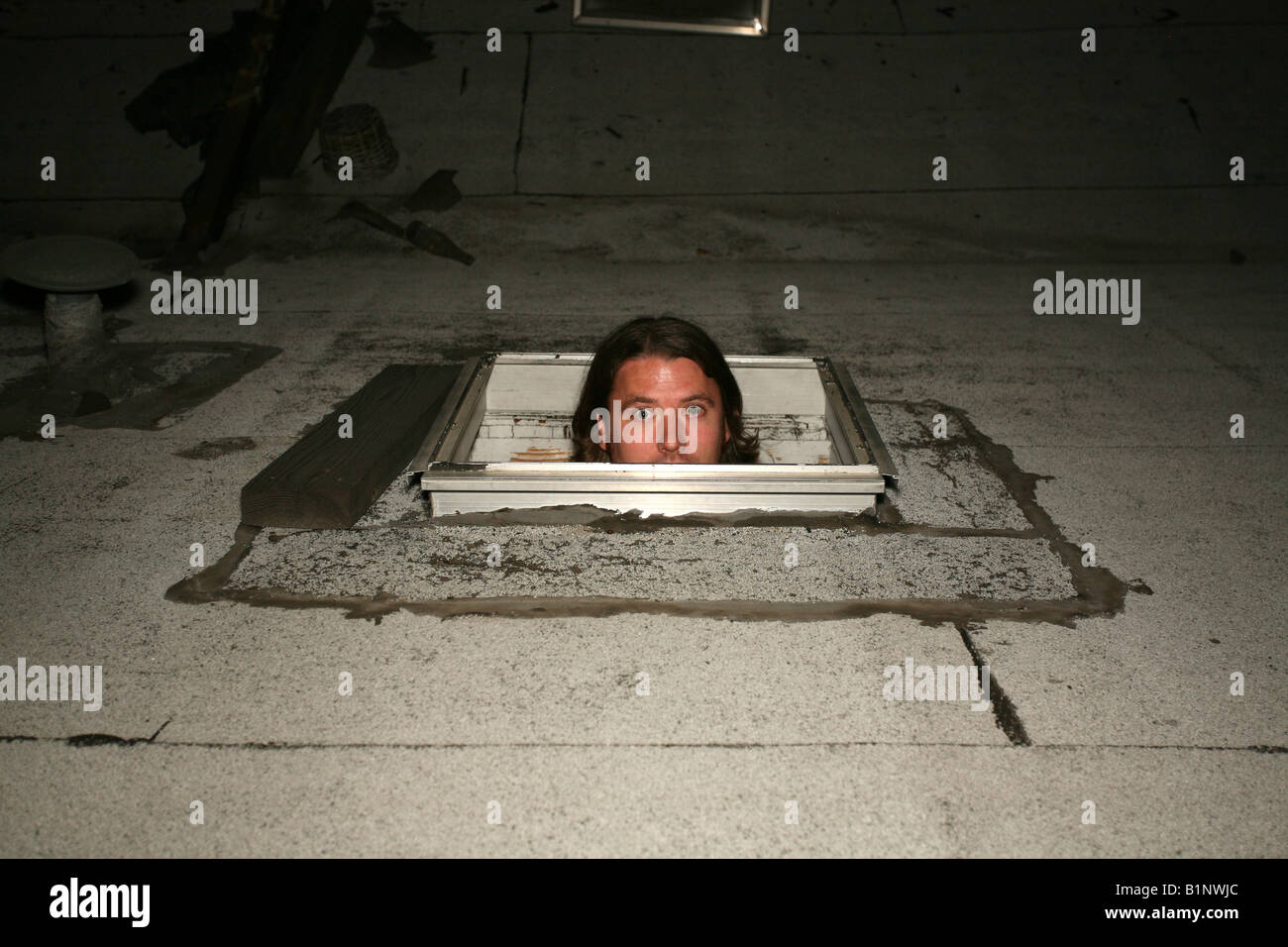 Young Male peeping head out of opening on roof Stock Photo - Alamy