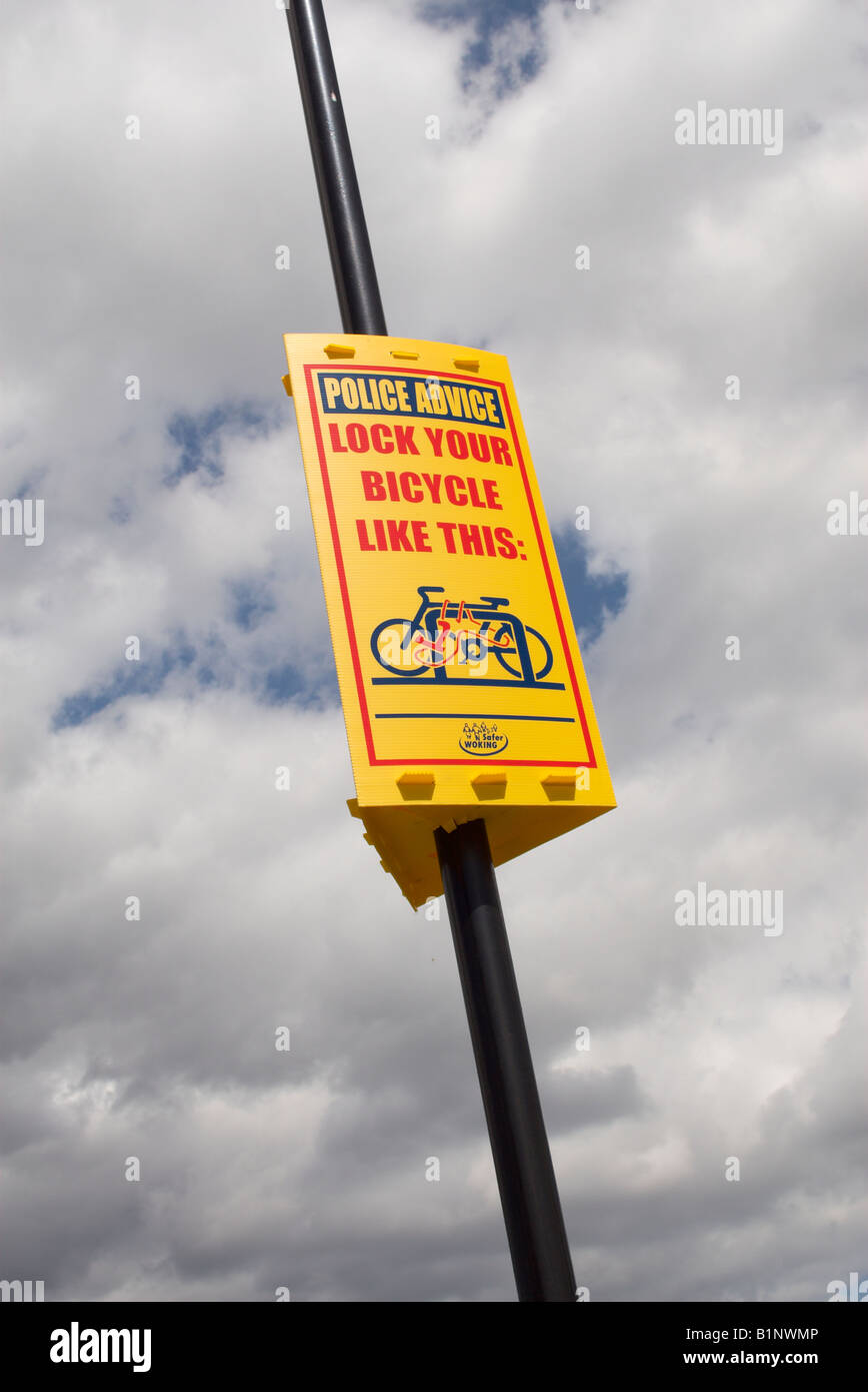 Sign on a post leaning to the left Police Advice lock your bicycle like ...