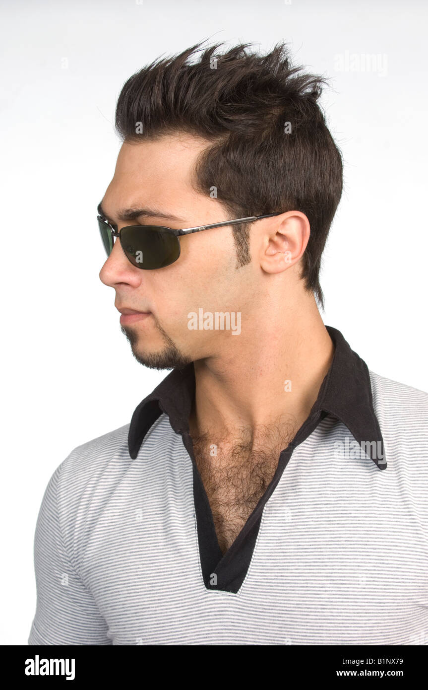 Profile portrait of a Middle eastern man wearing sunglasses against a ...