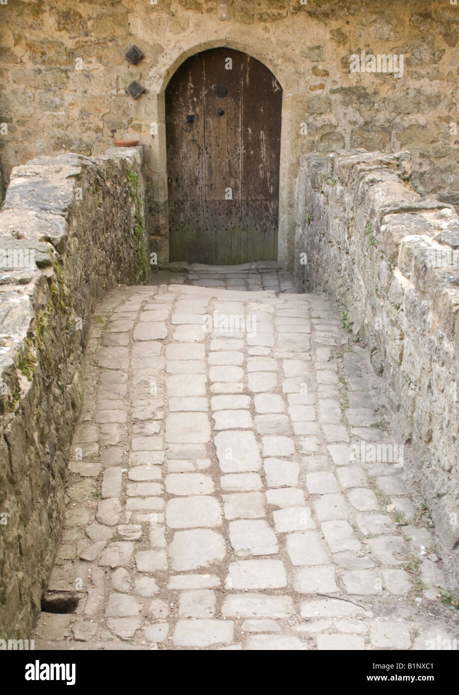 A small bridge and door at the end leading to a castle Stock Photo - Alamy