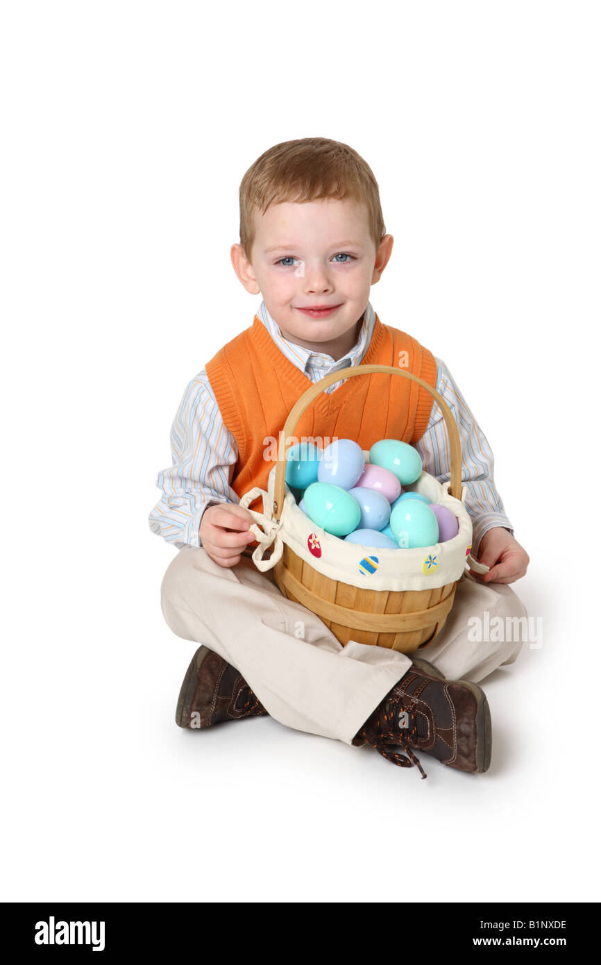 Young boy sitting with a basket of easter eggs cut out on white ...
