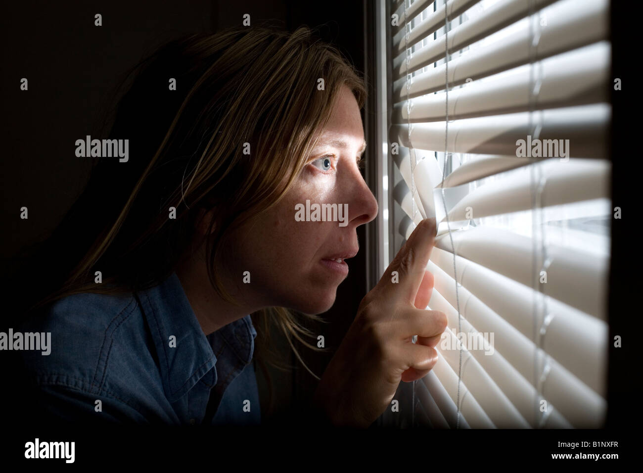 woman peeking out blinds Stock Photo - Alamy