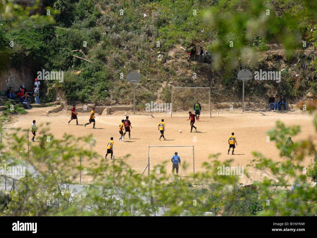 Football or soccer game being played on a "dirt pitch", Barcelona ...