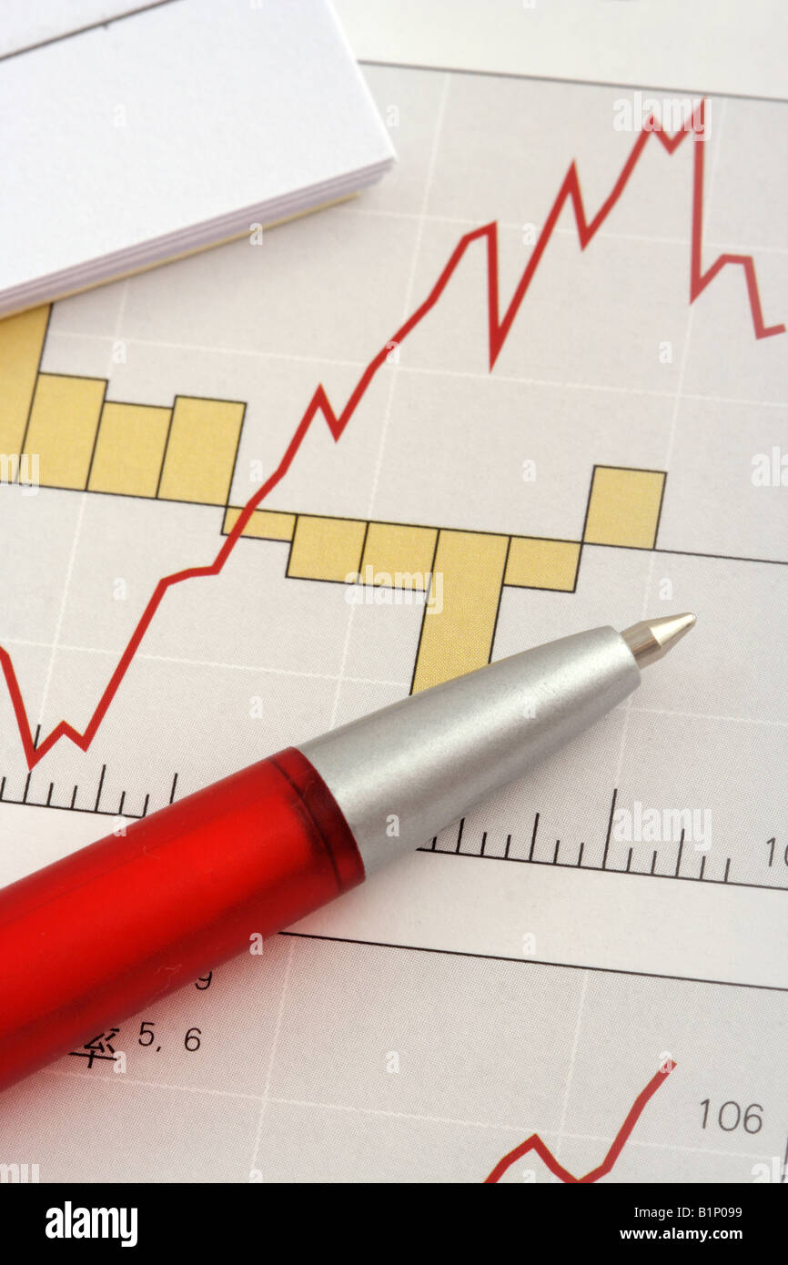 pen on graph with notebook on the upper left Stock Photo - Alamy