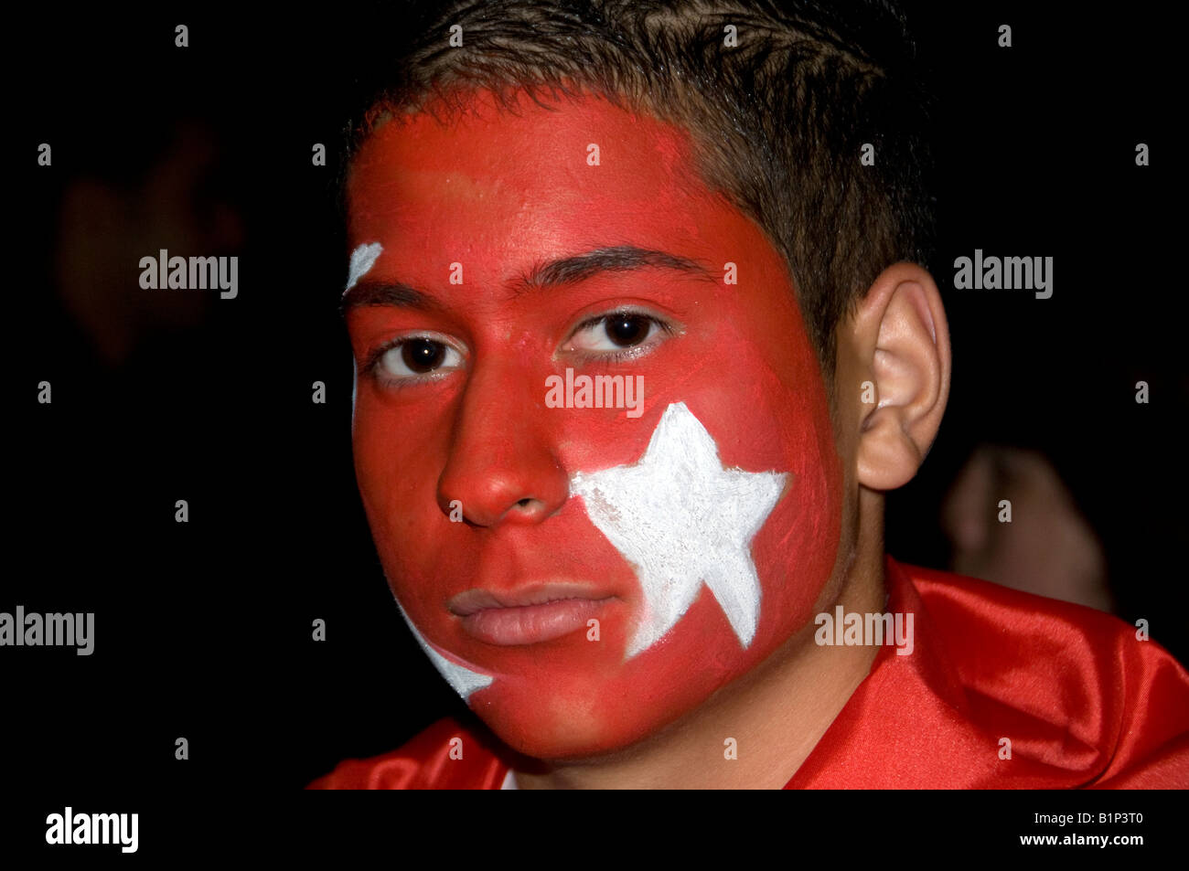 Young German with Turkish roots with Turkey flag painted on his face ...
