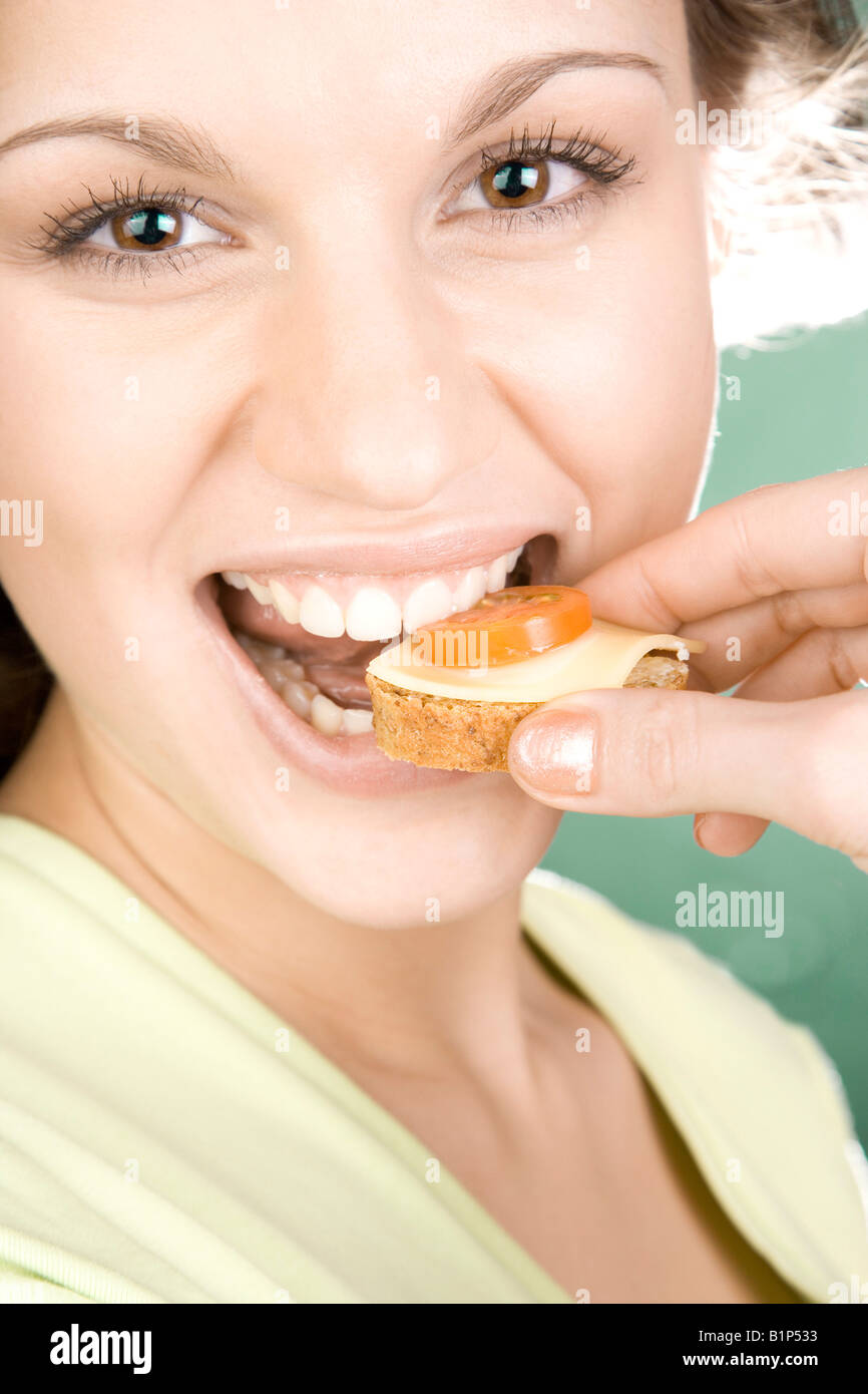 Woman eating sandwich Stock Photo - Alamy