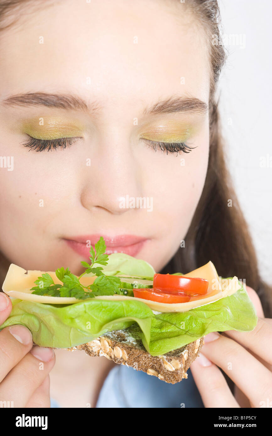 Young woman eating sandwich Stock Photo - Alamy