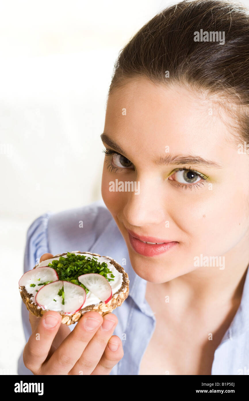 Young woman eating sandwich Stock Photo - Alamy