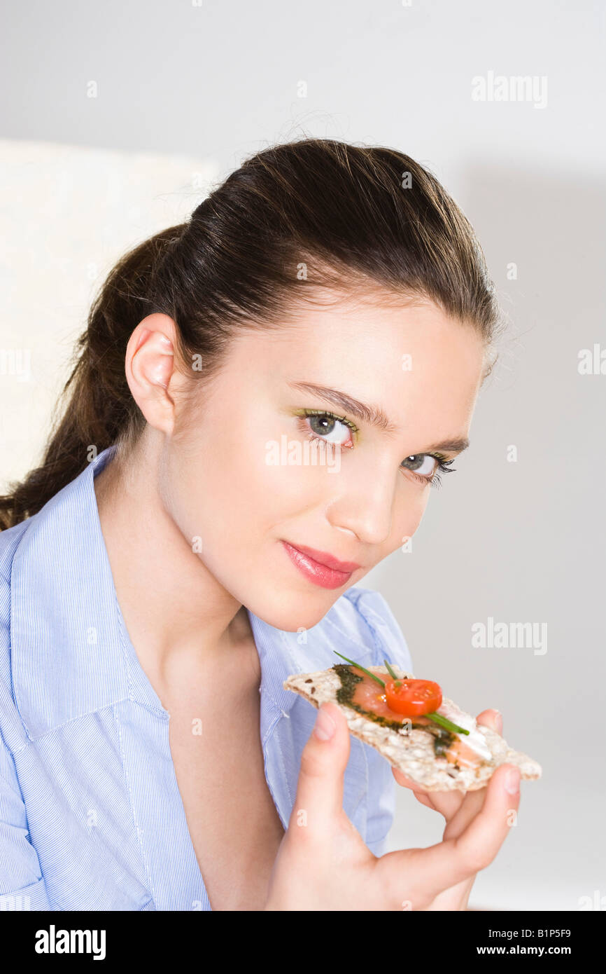 Young woman eating sandwich Stock Photo - Alamy
