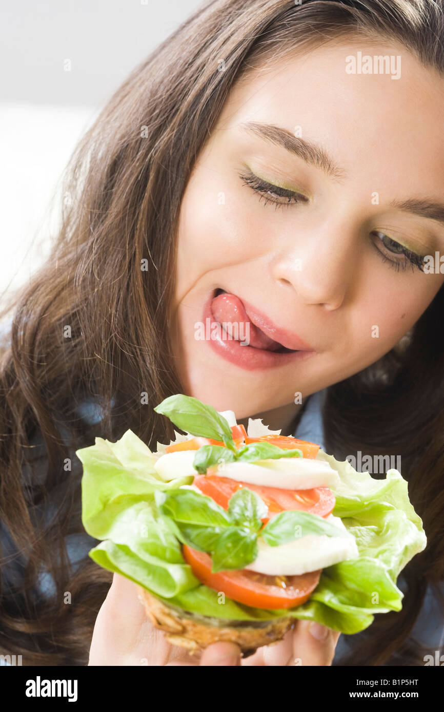 Young woman holding sandwich Stock Photo - Alamy