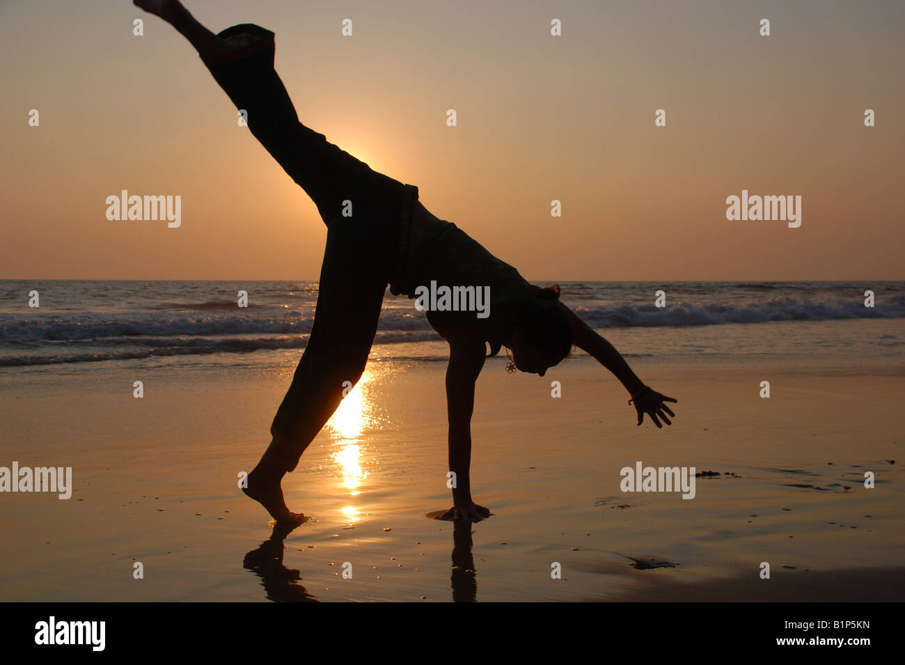 female cartwheeling on Indian beach Stock Photo - Alamy