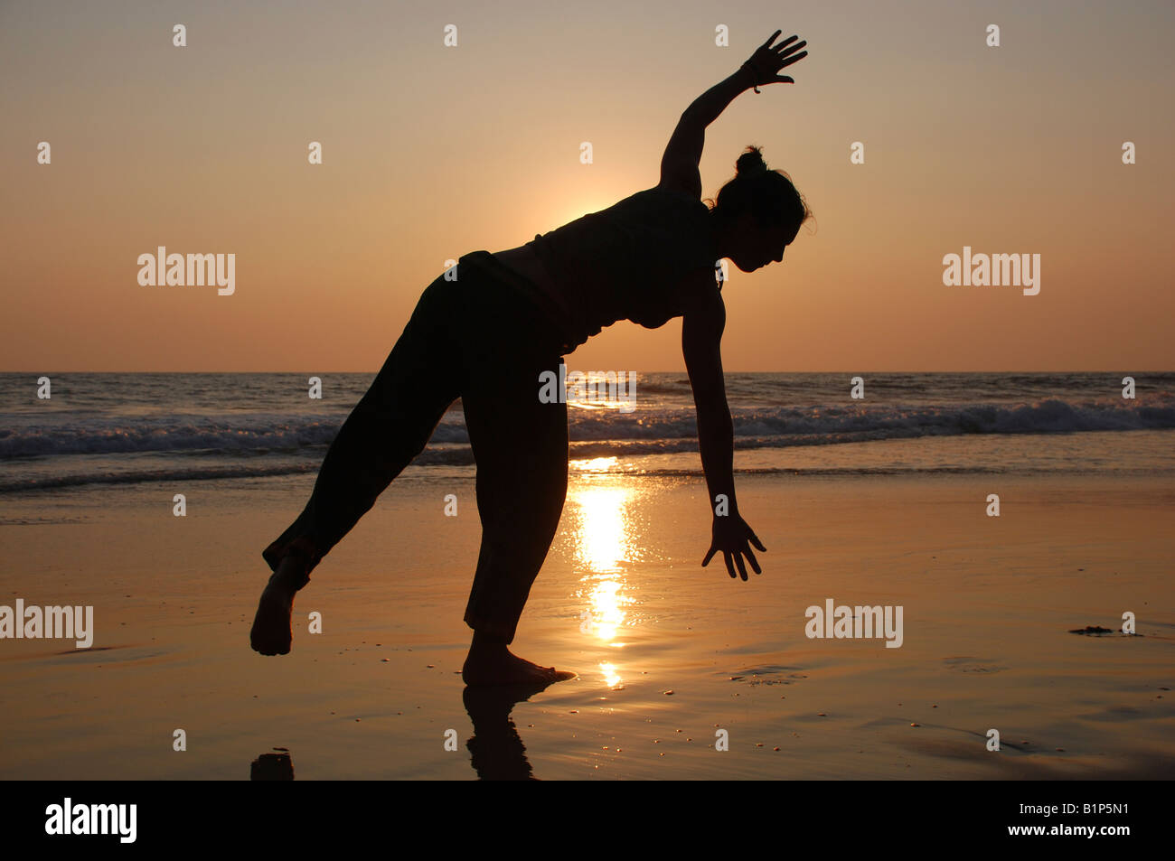 female cartwheeling on Indian beach Stock Photo - Alamy