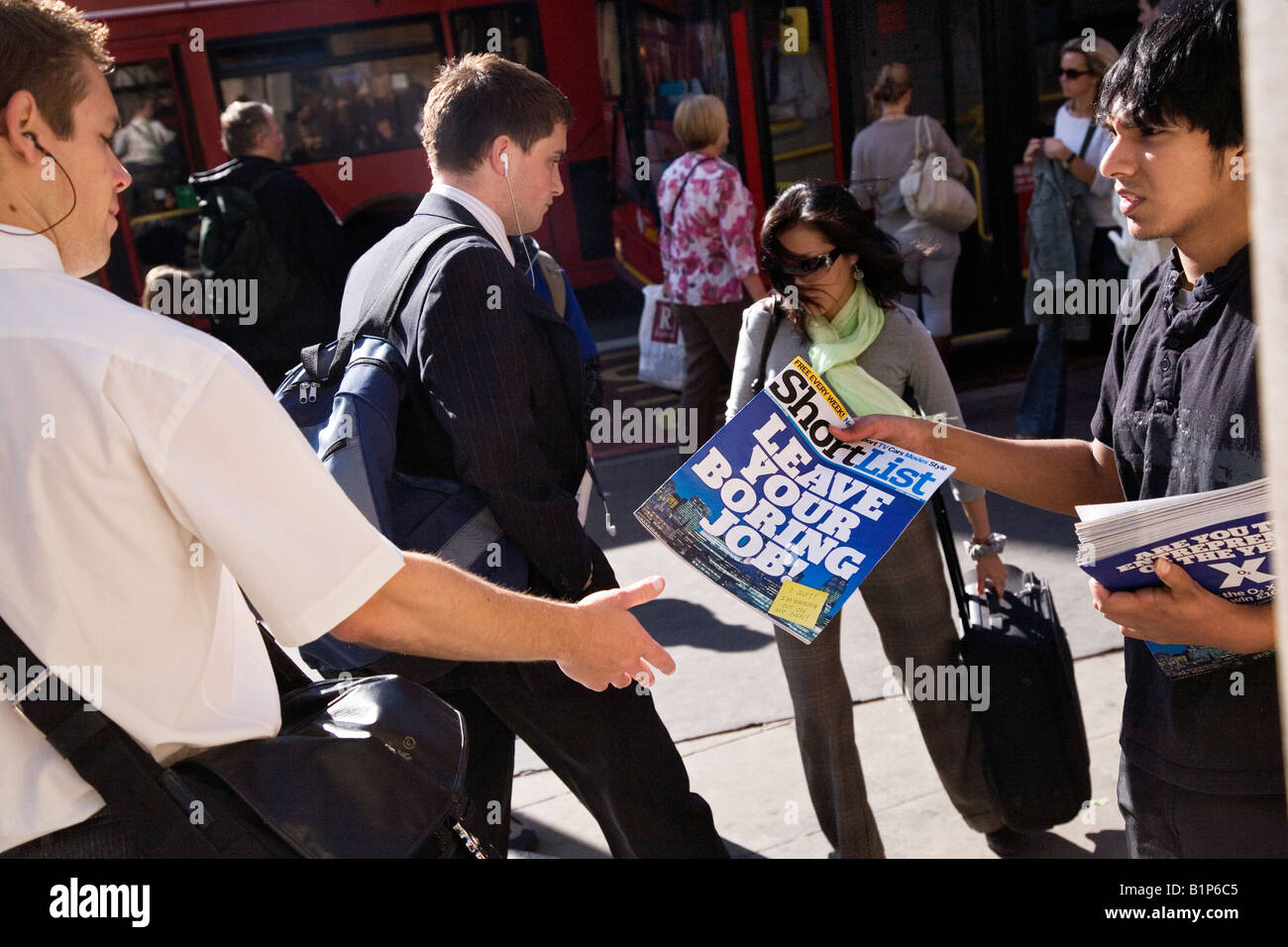 a man handing out a magazine in London Stock Photo - Alamy