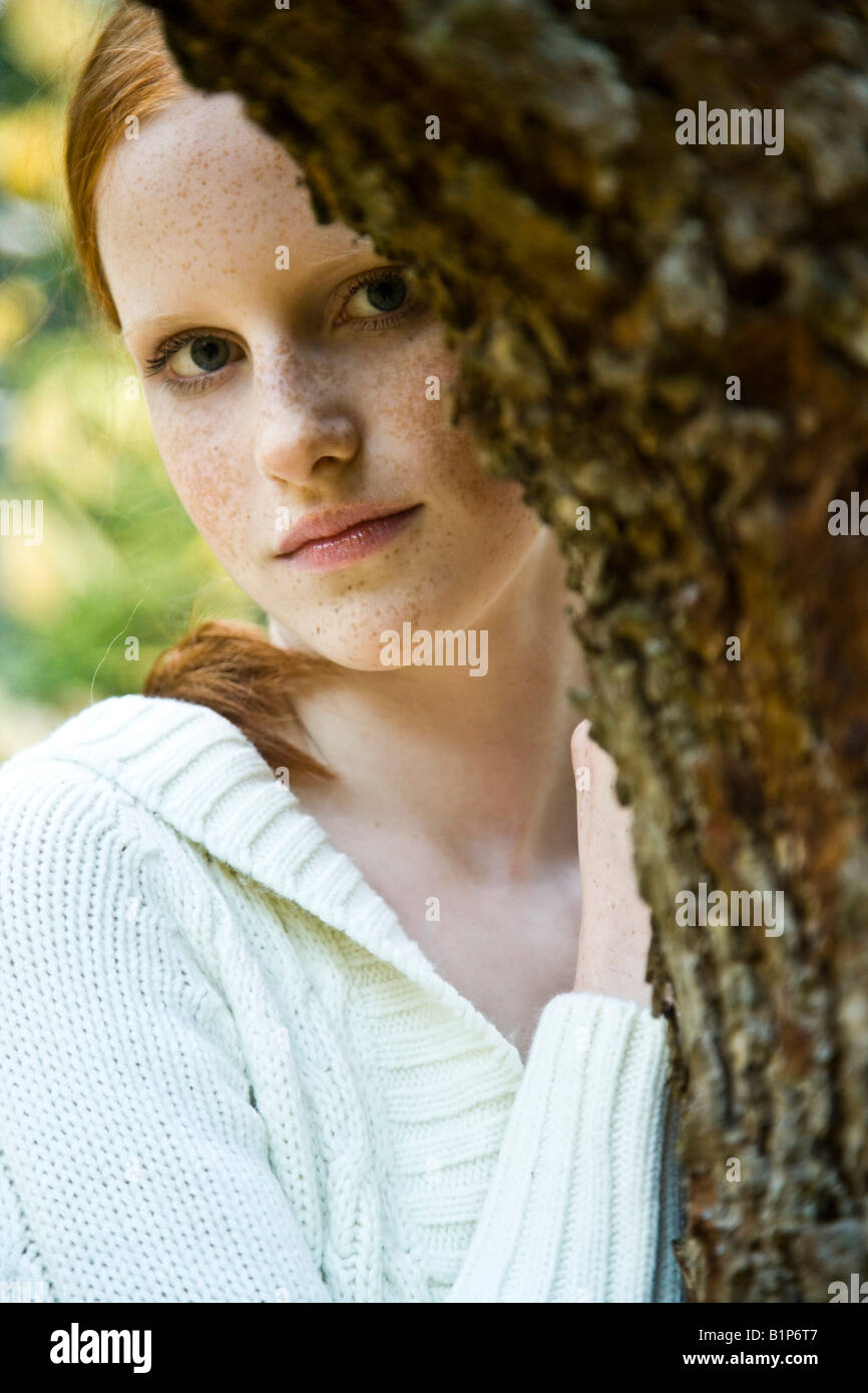 Portrait of girl next to tree Stock Photo - Alamy