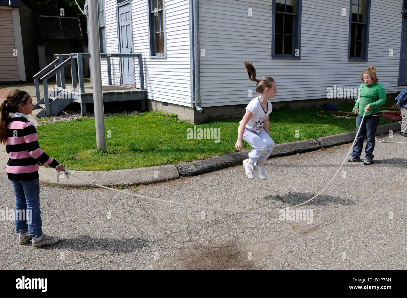 elementary children skipping rope for fun Stock Photo - Alamy