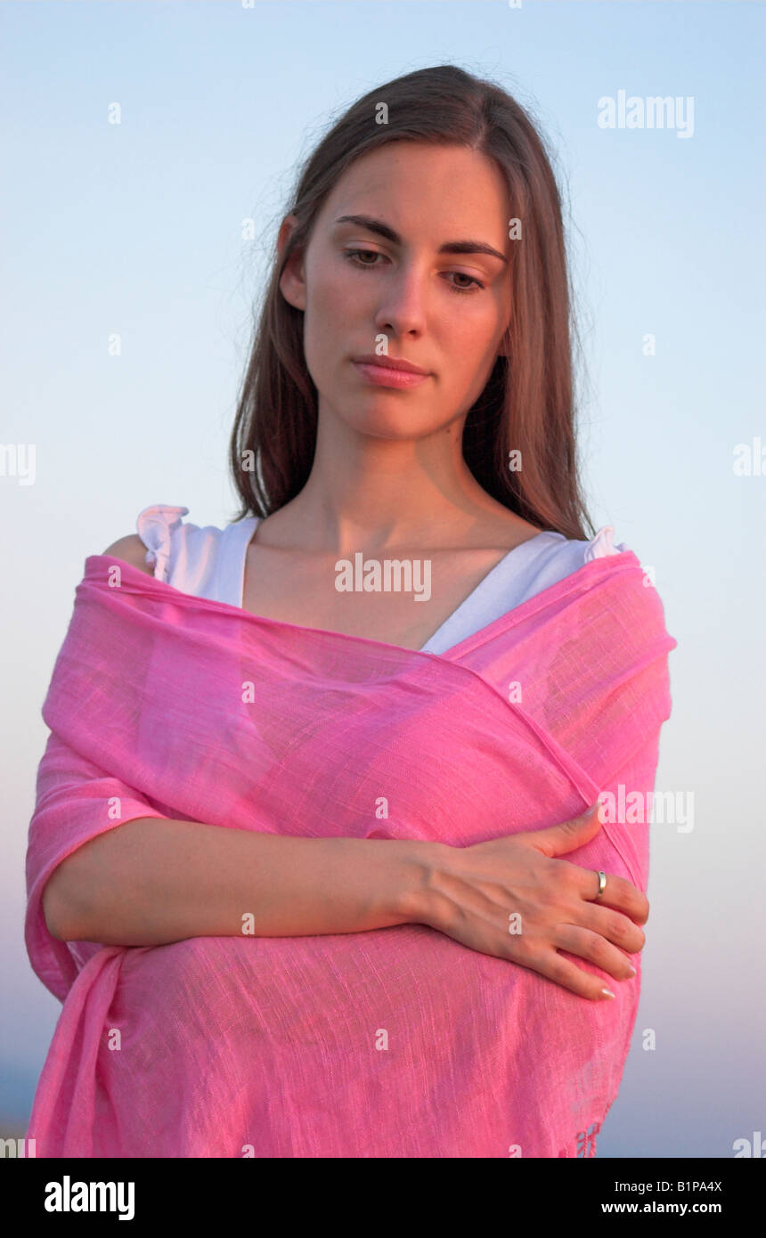 Portrait of a beautiful young woman outdoors looking down Stock Photo ...