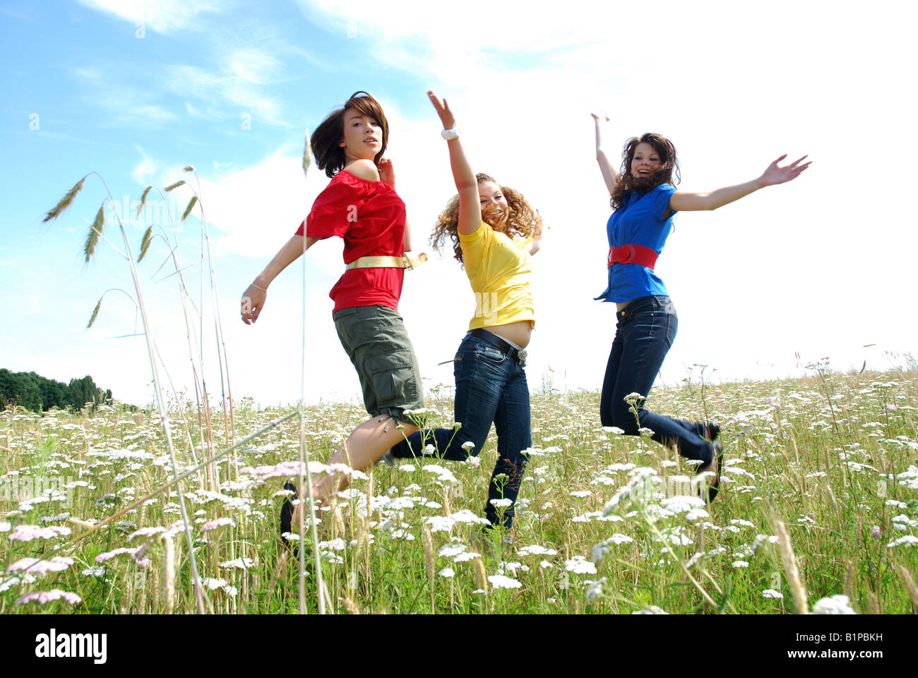 three young teenage girls in field Stock Photo - Alamy