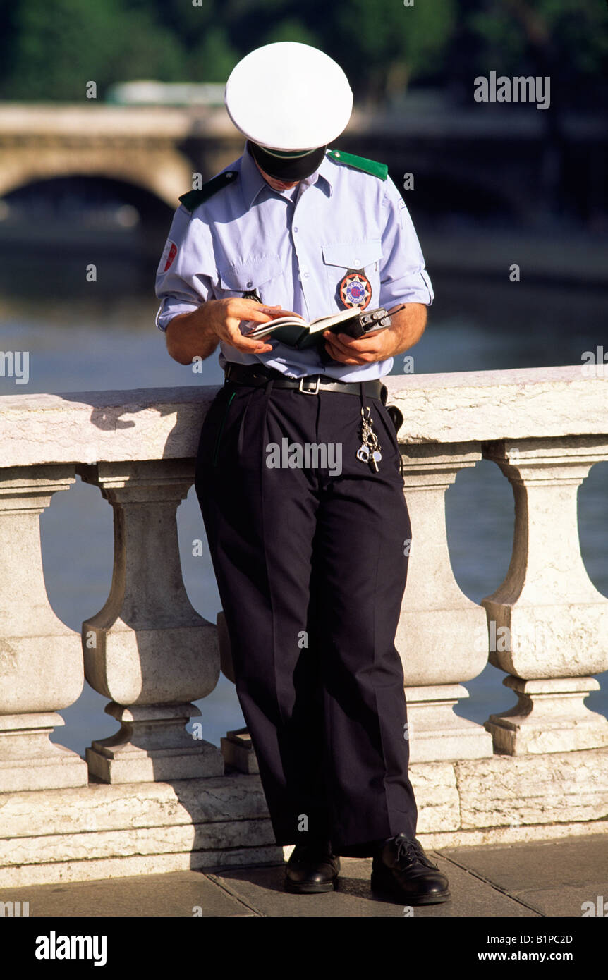 A policman on a bridge over the Seine in Paris, France Stock Photo - Alamy