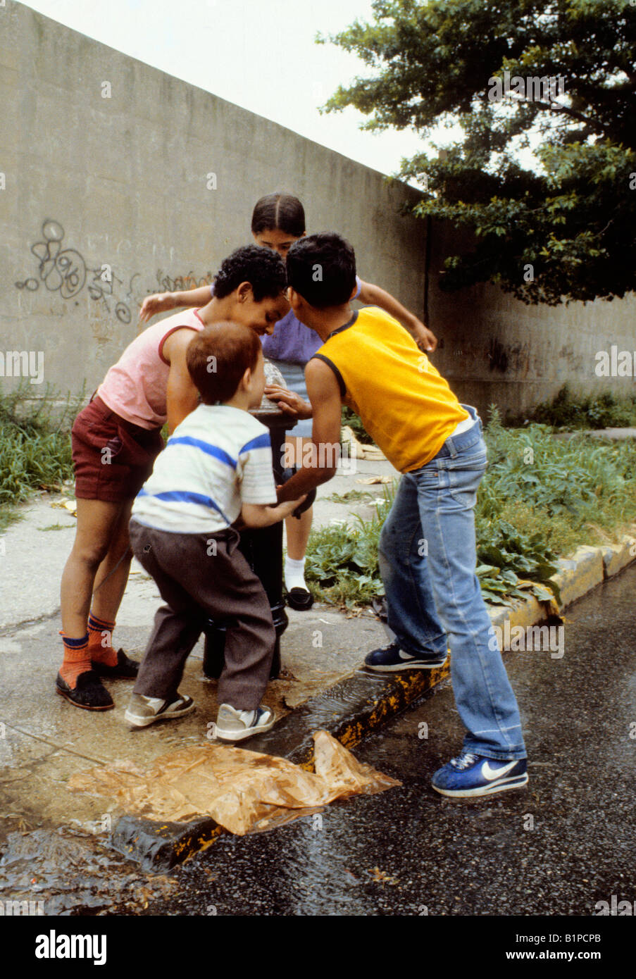 Kids playing fire hydrant hi-res stock photography and images - Alamy