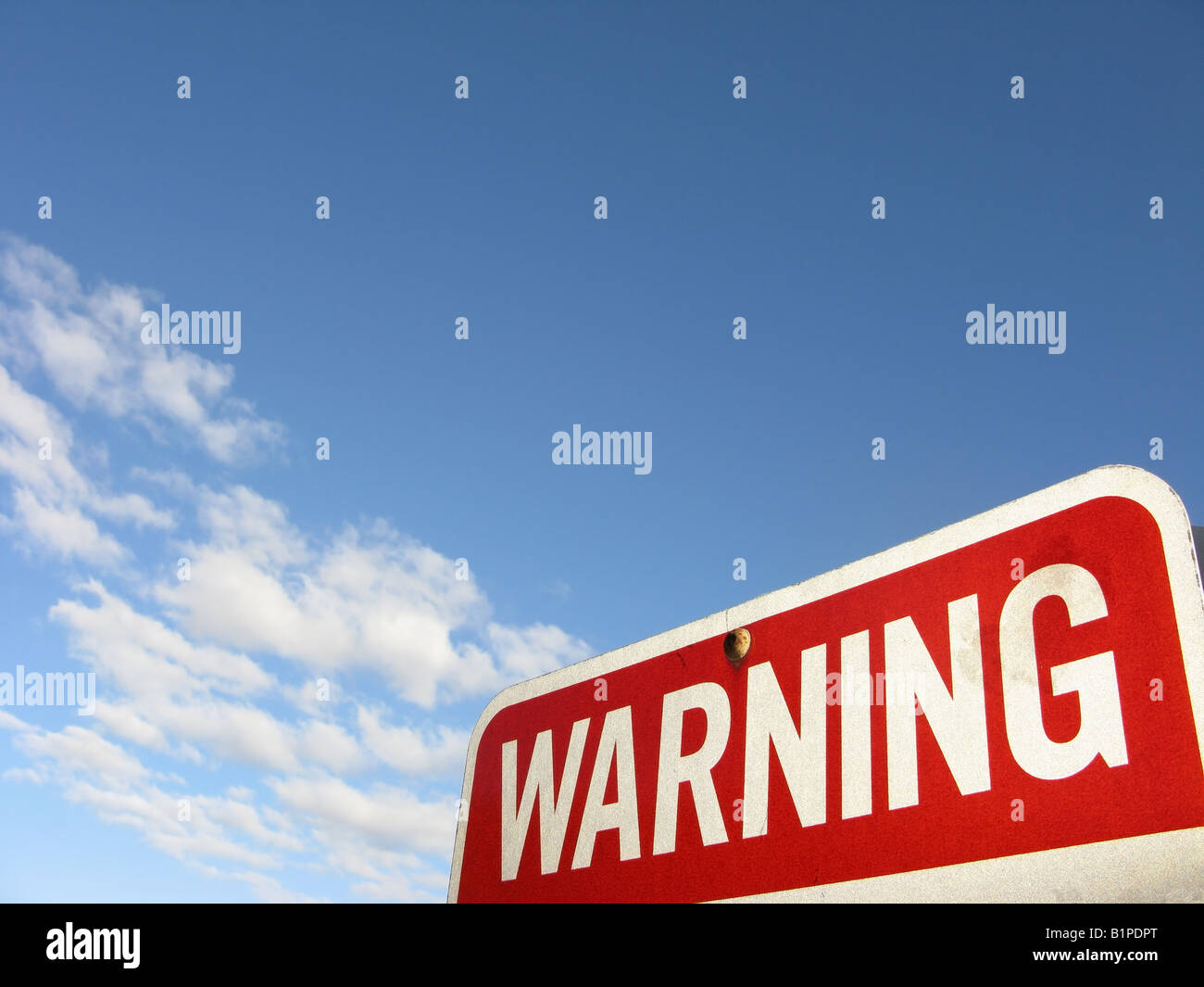 Red warning sign against blue sky Stock Photo - Alamy