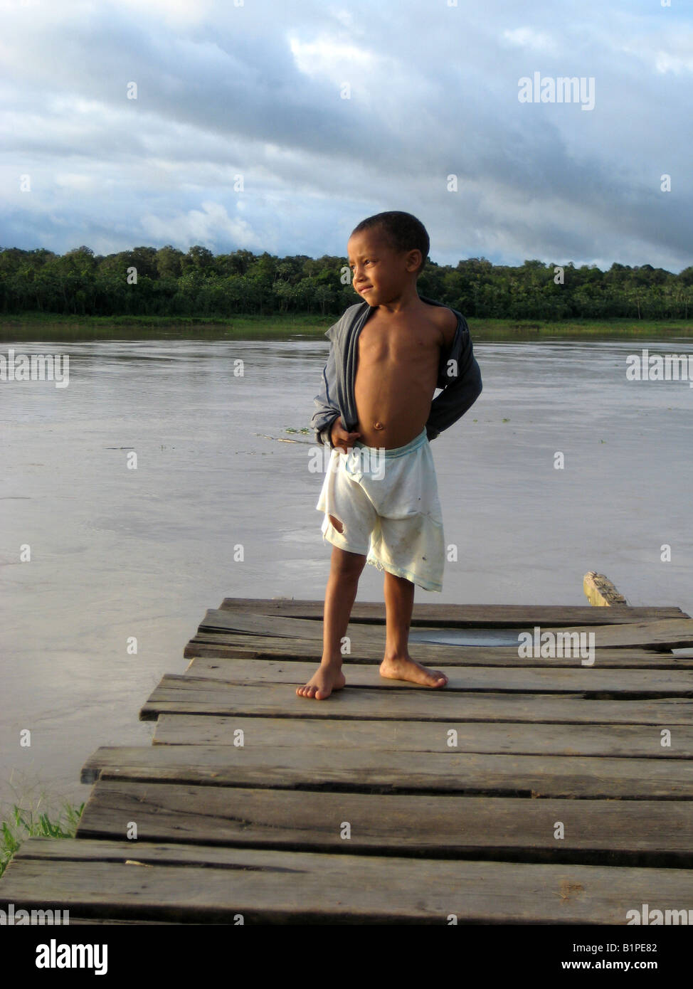 Boy watching river Stock Photo - Alamy
