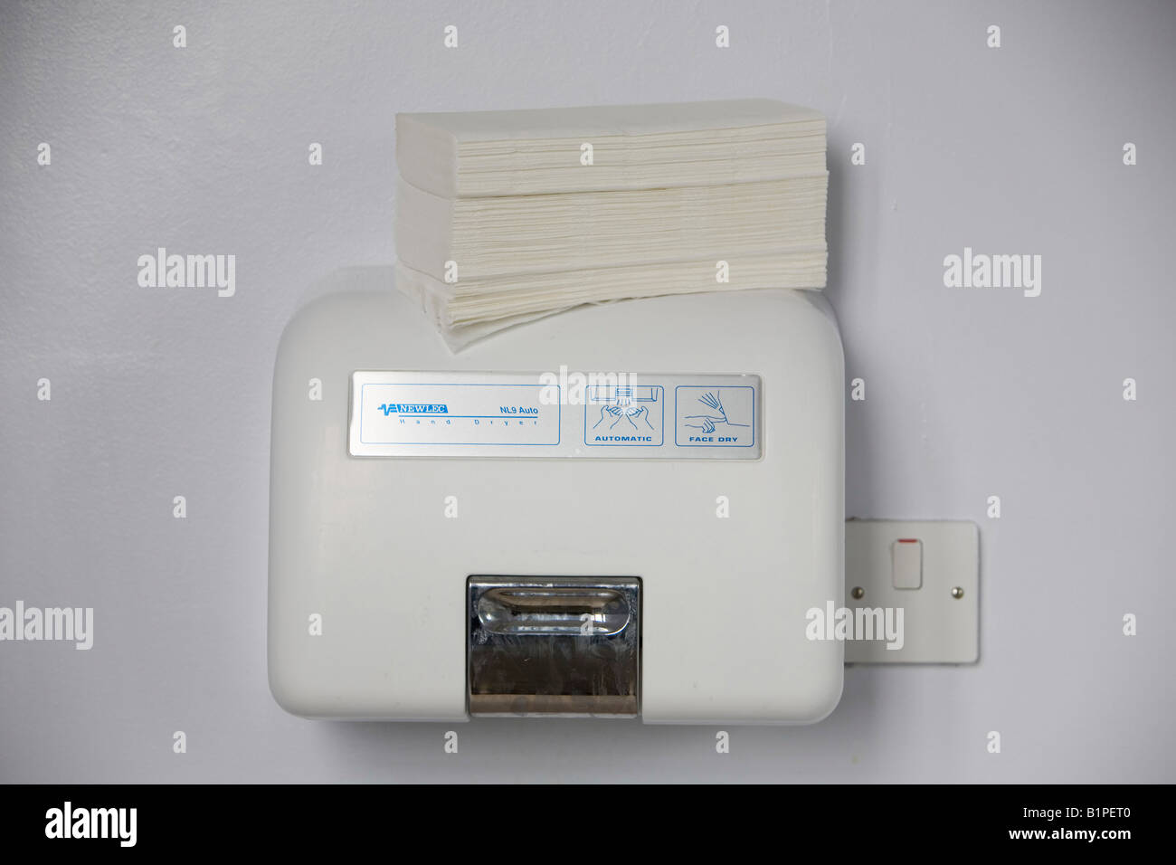 A toilet block with a choice of drying hands with either paper towels ...