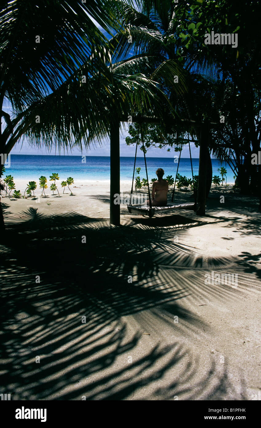 Woman relaxing on a swing in the shade, Cocoa island, Maldives Stock ...
