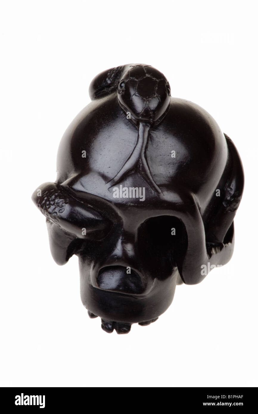 Netsuke skull and snake Stock Photo - Alamy
