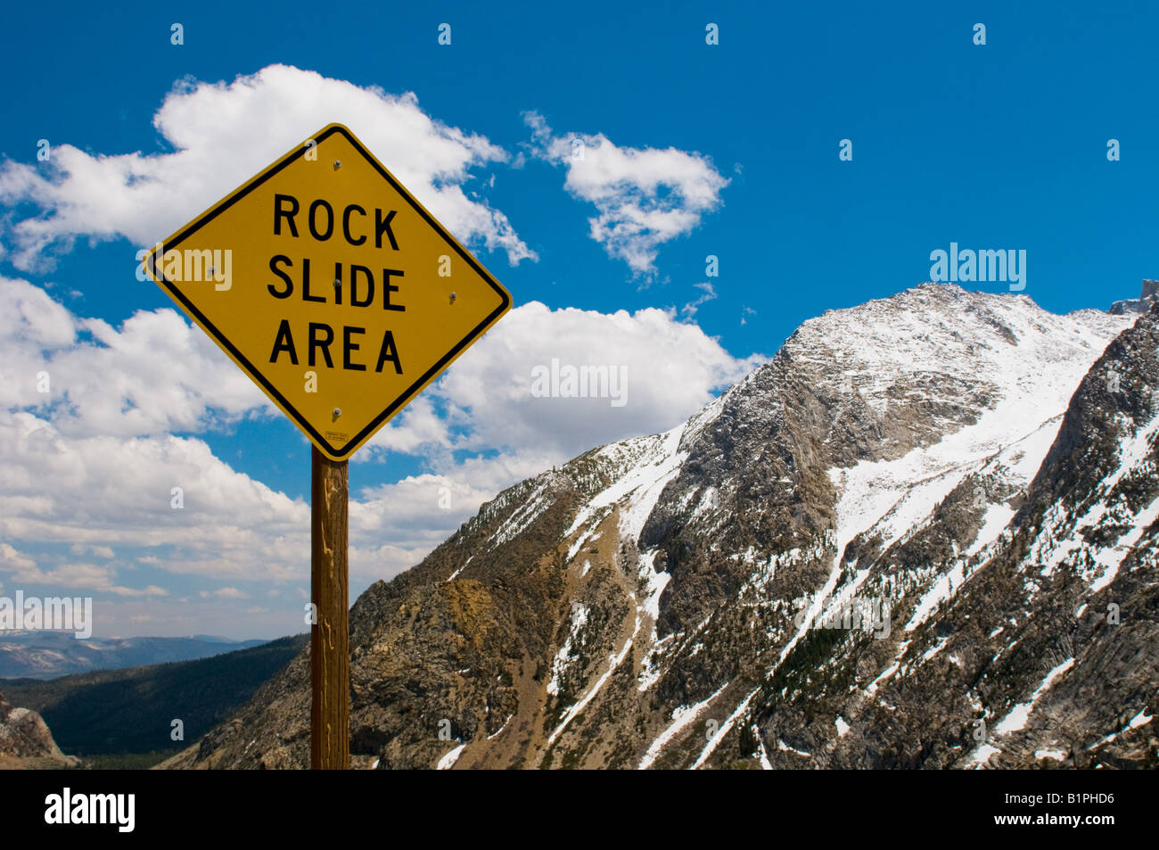 Rock slide area sign in the mountains Stock Photo - Alamy