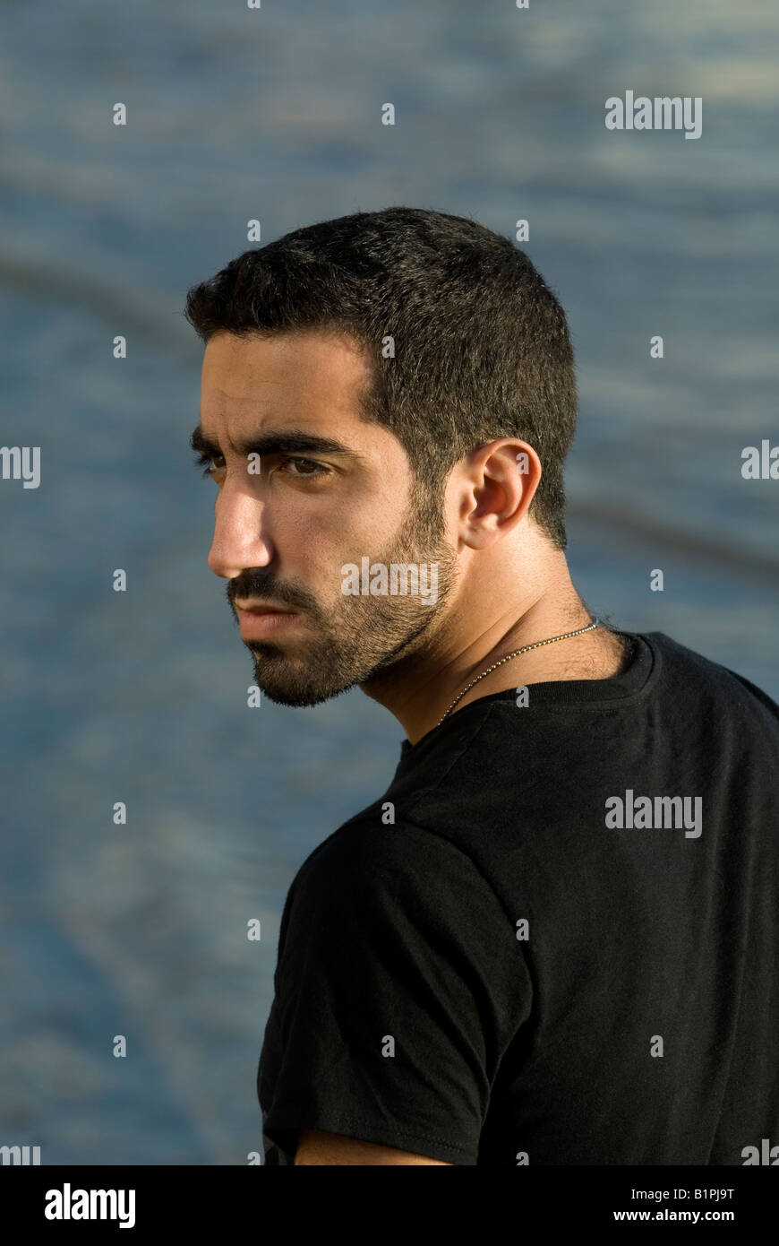 Portrait of an Arabic man looking to the side outdoors Stock Photo - Alamy