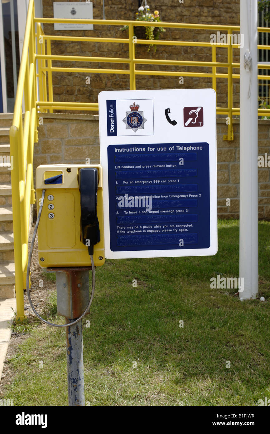 A telephone and information sign outside a police station for use when ...