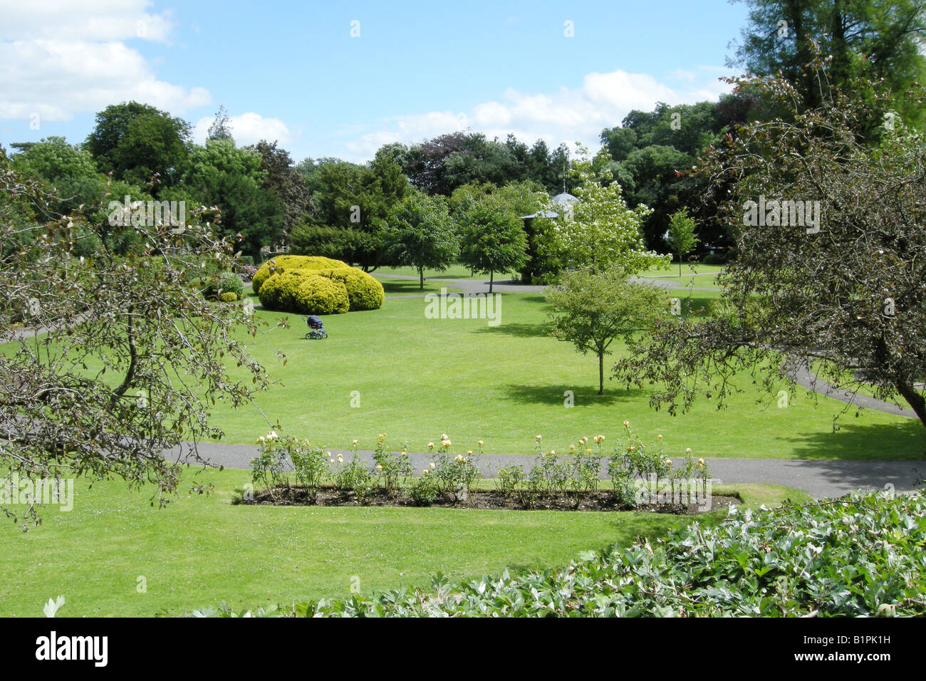 A victorian british park set out with trees and rose bushes Stock Photo ...
