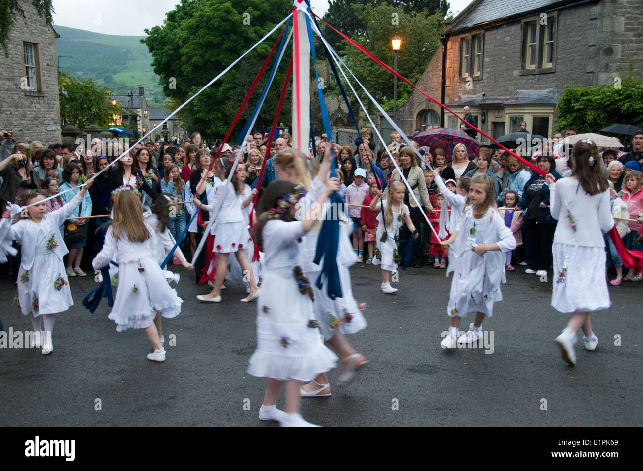 Young girls dancing round a Maypole Castleton Derbyshire Peak District ...