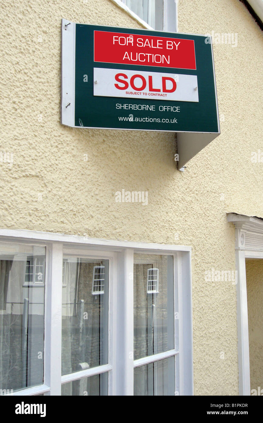 Property for auction sign with a sold attachment below Stock Photo - Alamy
