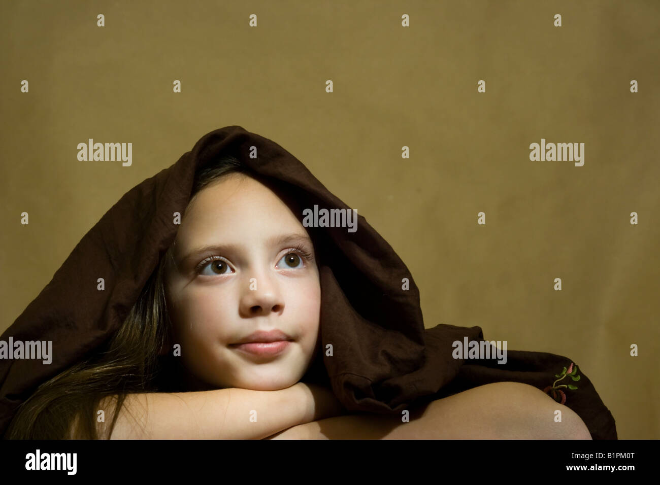 Photo of a girl with brown eyes and brown cloth over head Stock Photo ...