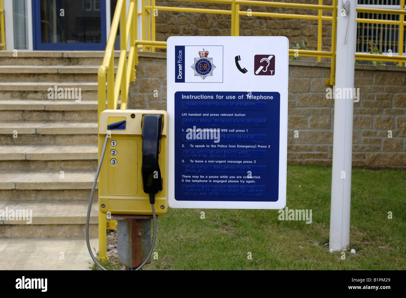 A telephone and information sign outside a police station for use when ...