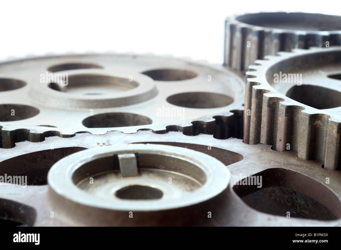 closeup on three cogwheels isolated on white Stock Photo - Alamy