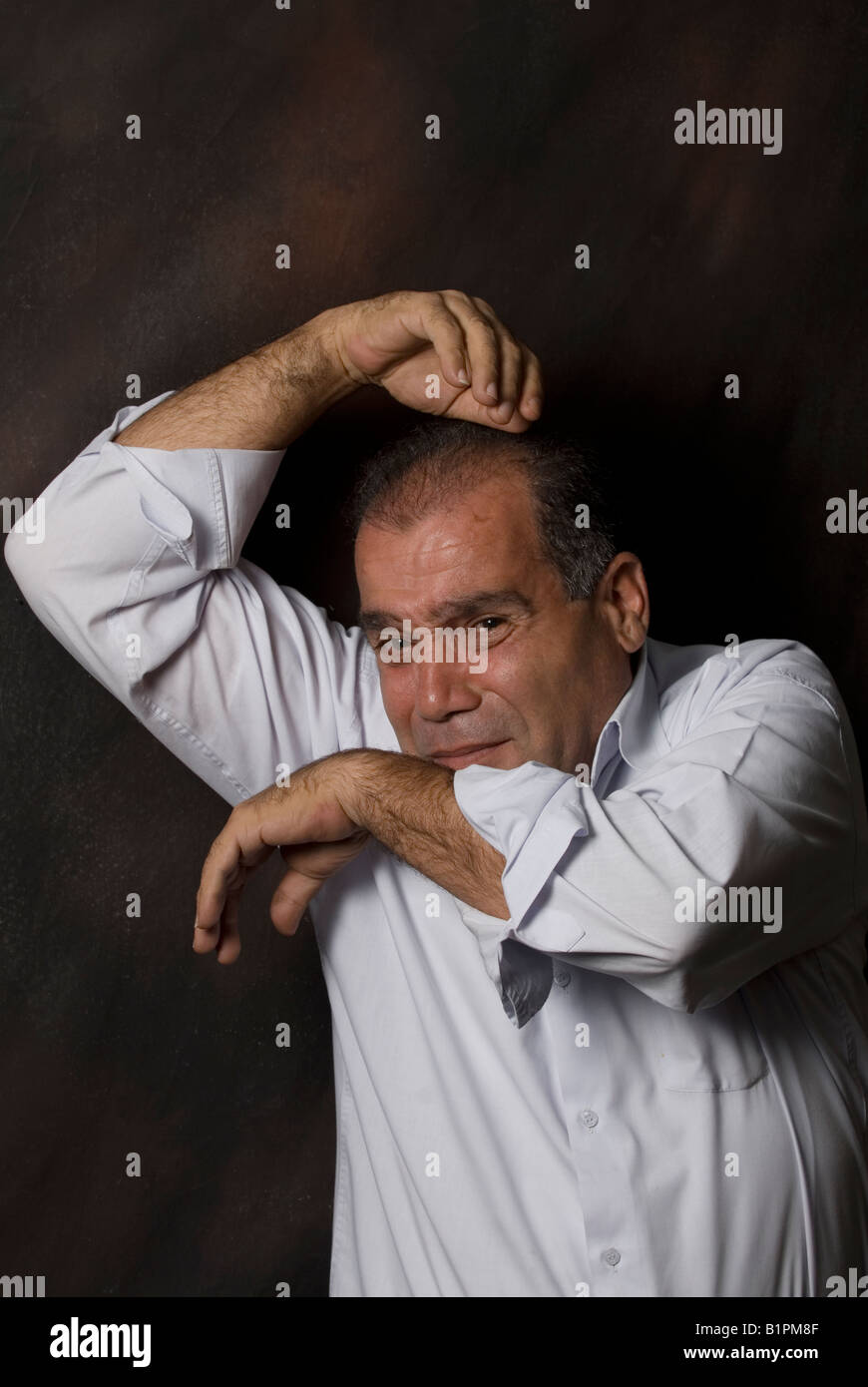Afraid mature man being tortured Stock Photo - Alamy